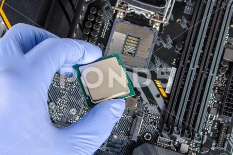 Plug in CPU microprocessor to motherboard socket. Technological background. C Stock Photo #263227620