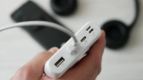 Plug the USB connector into the charger ... | Stock Video | Pond5