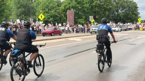 Police on bicycle patrol the streets dur... | Stock Video | Pond5