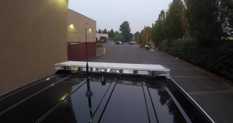 police car patrolling behind building | Stock Video | Pond5