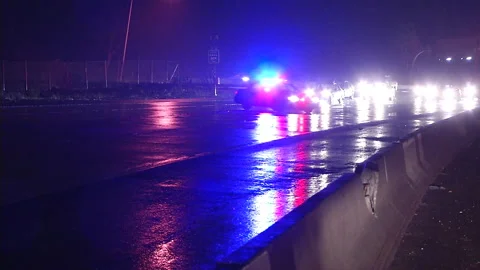 Police car stops traffic with round robi... | Stock Video | Pond5