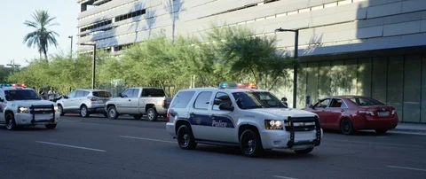 Police cars riding in a convoy on the st... | Stock Video | Pond5