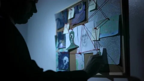 Police Detective Ties Together Clues On ... | Stock Video | Pond5