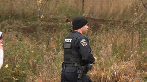 Police detectives dig crime scene lookin... | Stock Video | Pond5