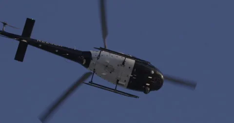 Police Helicopter Flies in Slow Motion O... | Stock Video | Pond5