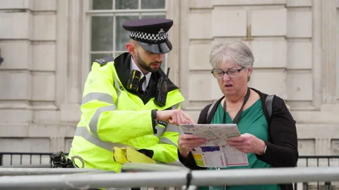 Police Officer Helps Tourist with Map an... | Stock Video | Pond5