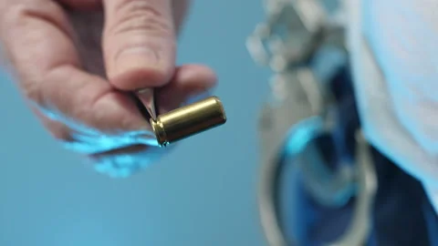 Police Officer Holds 9mm Shell Casing | Stock Video | Pond5