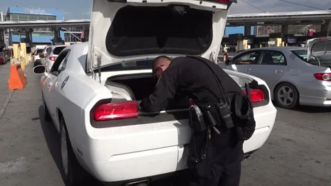 Police Officer inspecting trunk of vehic... | Stock Video | Pond5
