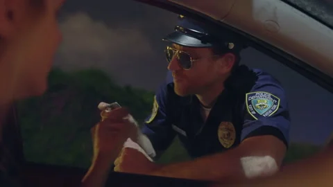 Police officer leans on car window, requ... | Stock Video | Pond5