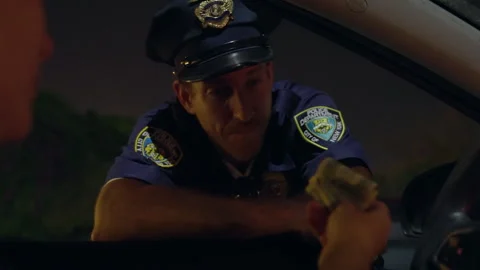 Police officer leans on a car window at ... | Stock Video | Pond5