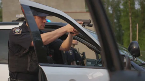 Police Officer Points His Firearm From B... | Stock Video | Pond5