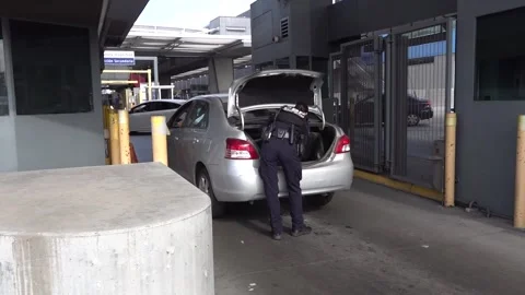 Police Officer searching trunk of vehicl... | Stock Video | Pond5