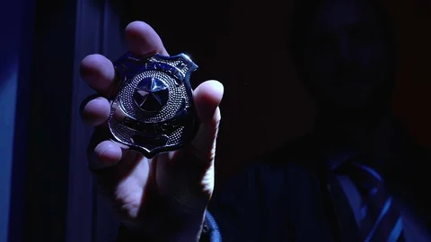 Police officer showing badge close-up, d... | Stock Video | Pond5