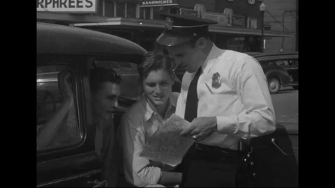 Police officer shows directions on map t... | Stock Video | Pond5