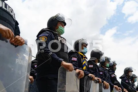 Photograph: Police officer team with weapons and riot shield protection ...