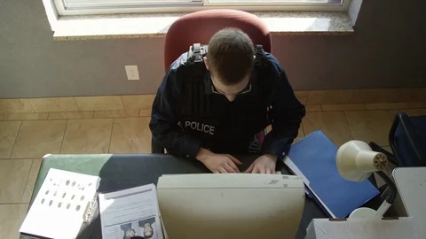 Police officer top view typing on comput... | Stock Video | Pond5