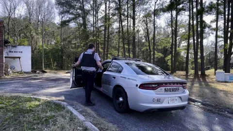 Police officer walking with paperwork to... | Stock Video | Pond5