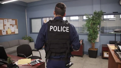 Police officer walking through the offic... | Stock Video | Pond5
