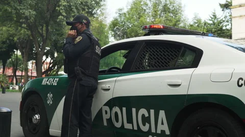 A police officer wearing a mask on surve... | Stock Video | Pond5