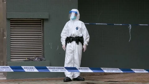 A police officer wearing a PPE suit in f... | Stock Video | Pond5