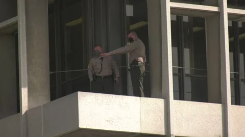 police overlooking crowd from building | Stock Video | Pond5