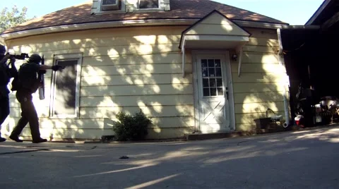 Police SWAT Team approaches a house | Stock Video | Pond5