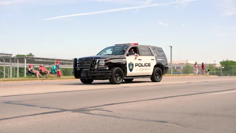 Police vehicle going by in July 4th Para... | Stock Video | Pond5