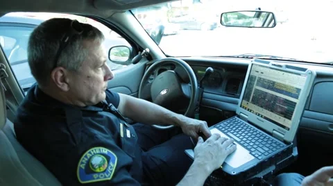 Policeman typing on a his laptop in his ... | Stock Video | Pond5