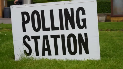 Polling station sign on a lawn with vote... | Stock Video | Pond5