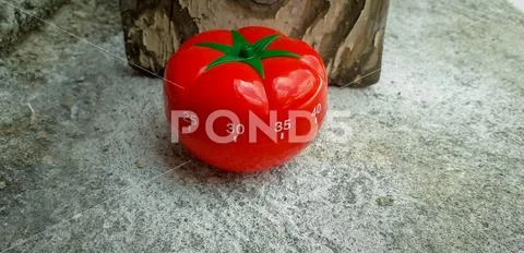 Pomodoro Timer in background of old vintage brick wall. ~ Hi Res #104978893