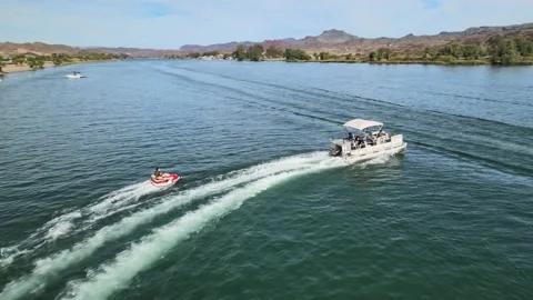 Pontoon Boat Tows Inner Tube Into Anothe... | Stock Video | Pond5