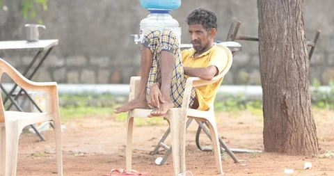 Poor Man sitting on a Chair | Stock Video | Pond5