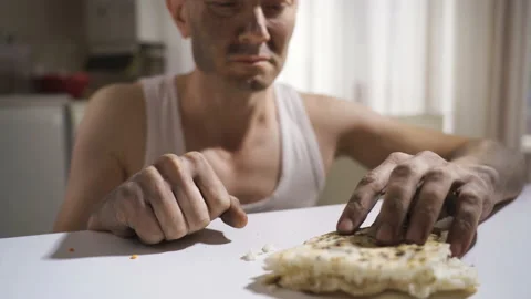 The poor man is unable to feed and is ex... | Stock Video | Pond5
