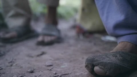 Poor men's dirty feet with torn shoes an... | Stock Video | Pond5