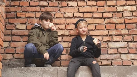 Poor street kids enjoy meal on street, e... | Stock Video | Pond5