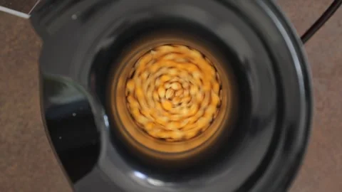 Pop corn kernel spinning in electric mac... | Stock Video | Pond5