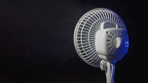Portable fan on a black background | Stock Video | Pond5