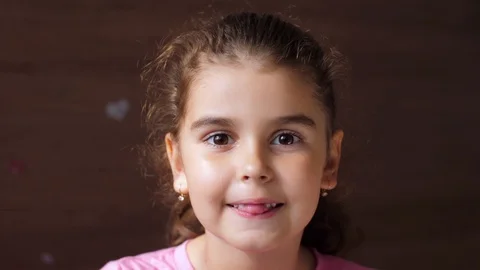 Portrait of a baby girl with a toothless... | Stock Video | Pond5