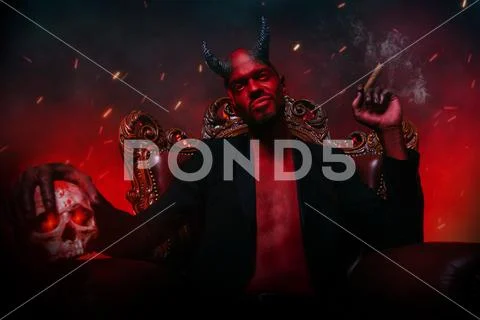 A portrait of a bad demon in his throne with a skull and cigar. Horror ...