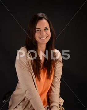 Portrait of beautiful female model on black background ~ Hi Res #48582448