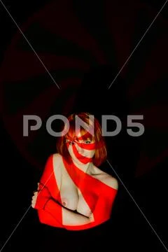 Photograph: Portrait of a beautiful naked woman in the red beams of the projector. #141077367