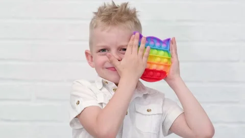 Portrait blonde boy with pop it sensory ... | Stock Video | Pond5