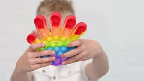 Portrait blonde boy with pop it sensory ... | Stock Video | Pond5