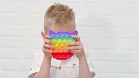 Portrait blonde boy with pop it sensory ... | Stock Video | Pond5