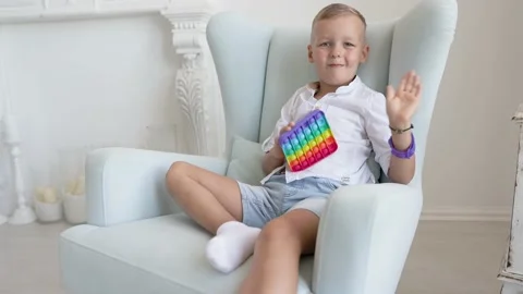 Portrait blonde boy with pop it sensory ... | Stock Video | Pond5