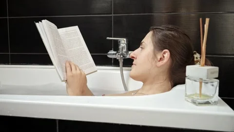 Portrait of brunette woman taking bath w... | Stock Video | Pond5
