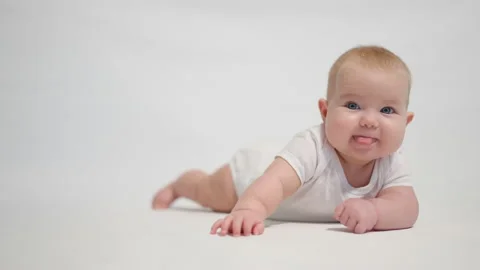 Portrait of a contented baby on a white ... | Stock Video | Pond5