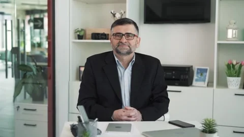 A portrait of a dignified man sitting at... | Stock Video | Pond5