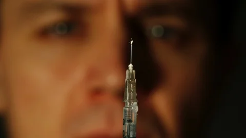 Portrait of drug addict looks at the syr... | Stock Video | Pond5