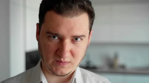 Portrait evil young man looking at camer... | Stock Video | Pond5